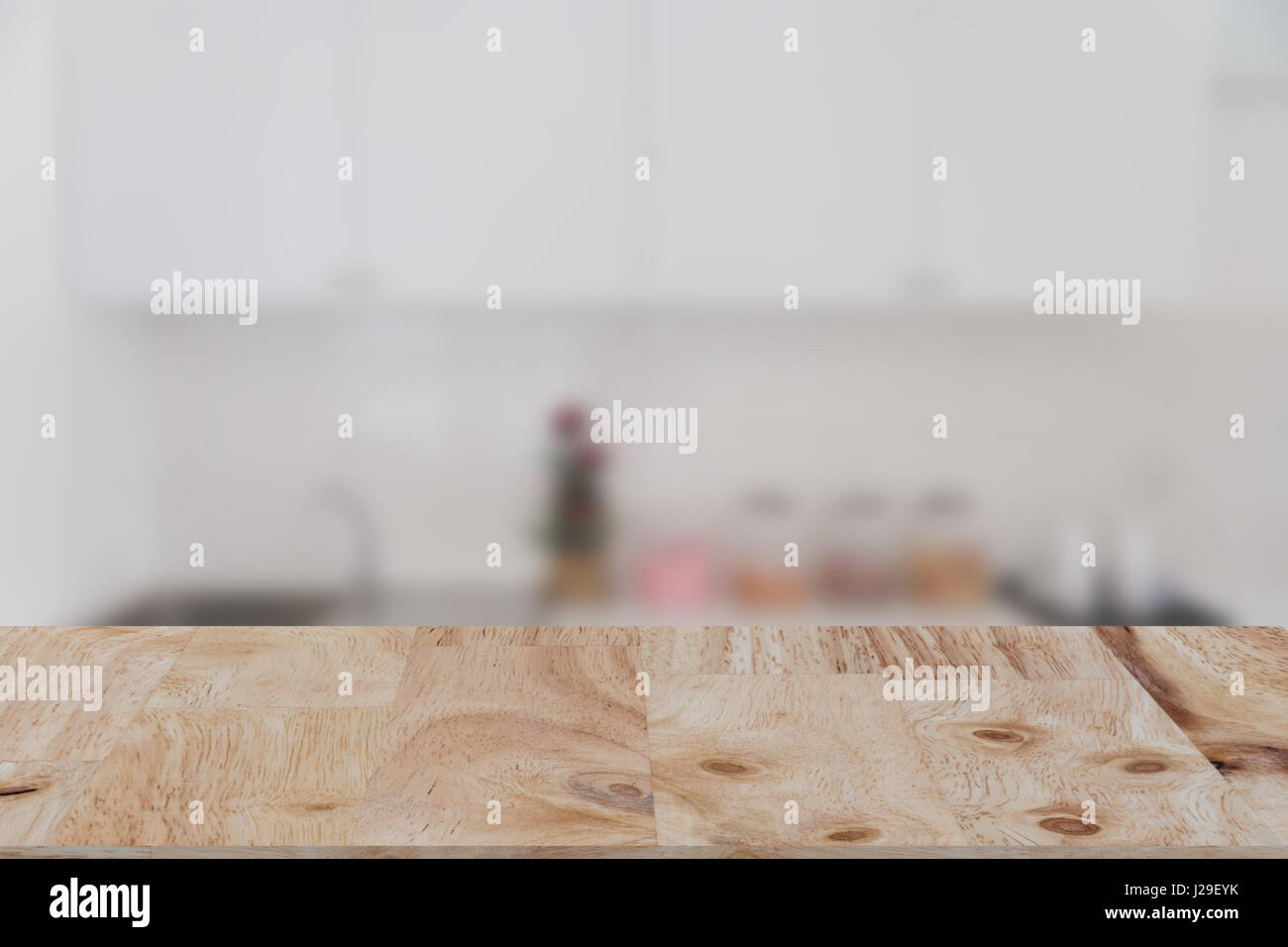 defocused modern white kitchen background with selected focus wood ...