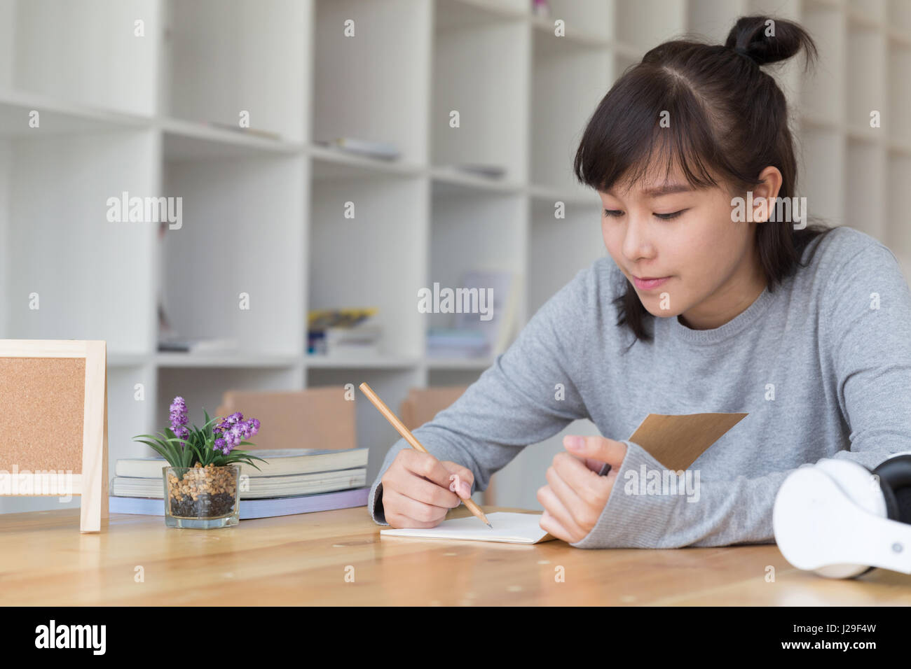 asian girl female teenager studying at school. Student writing note in ...