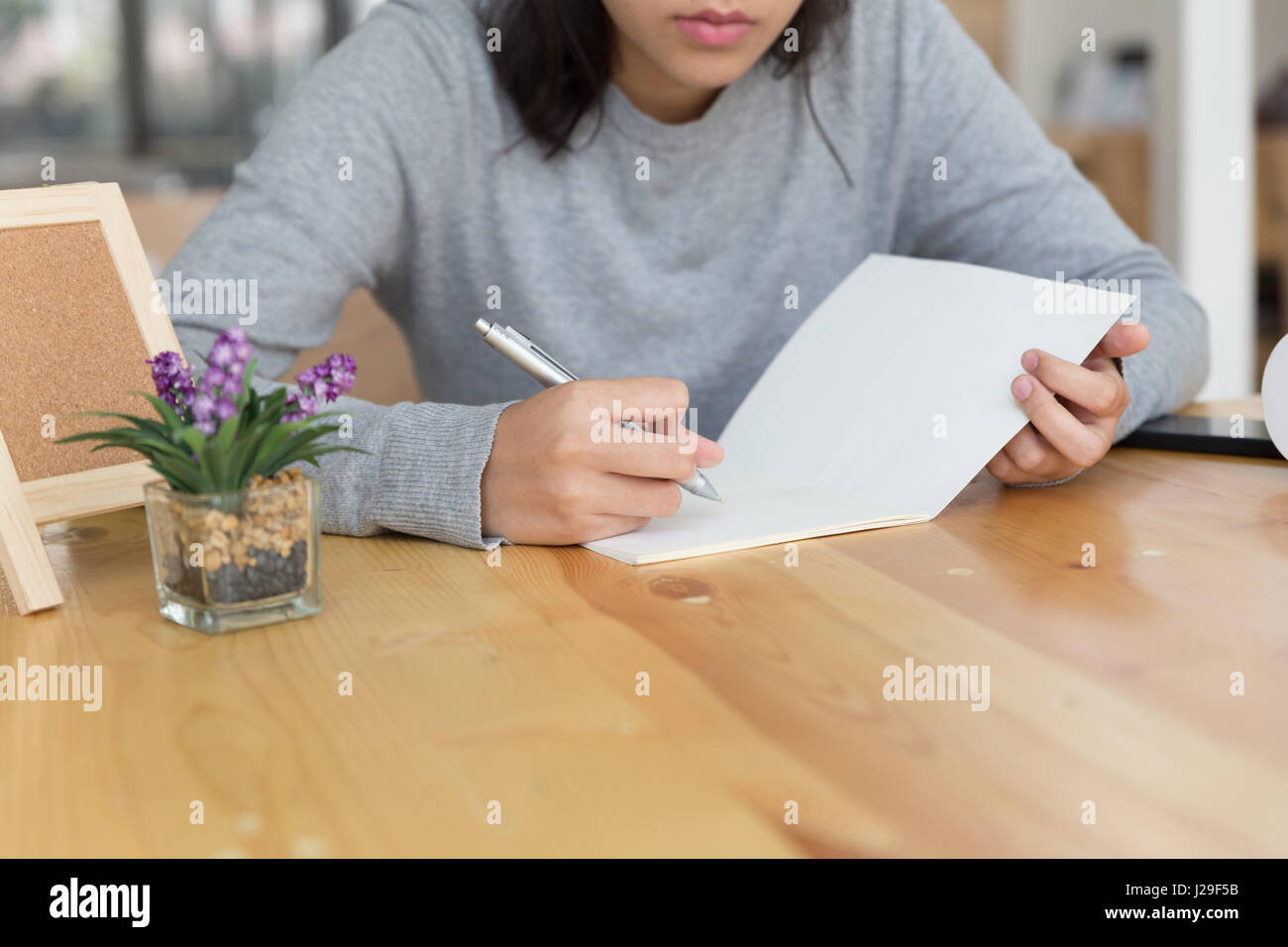 asian girl female teenager studying at school. Student writing note on ...