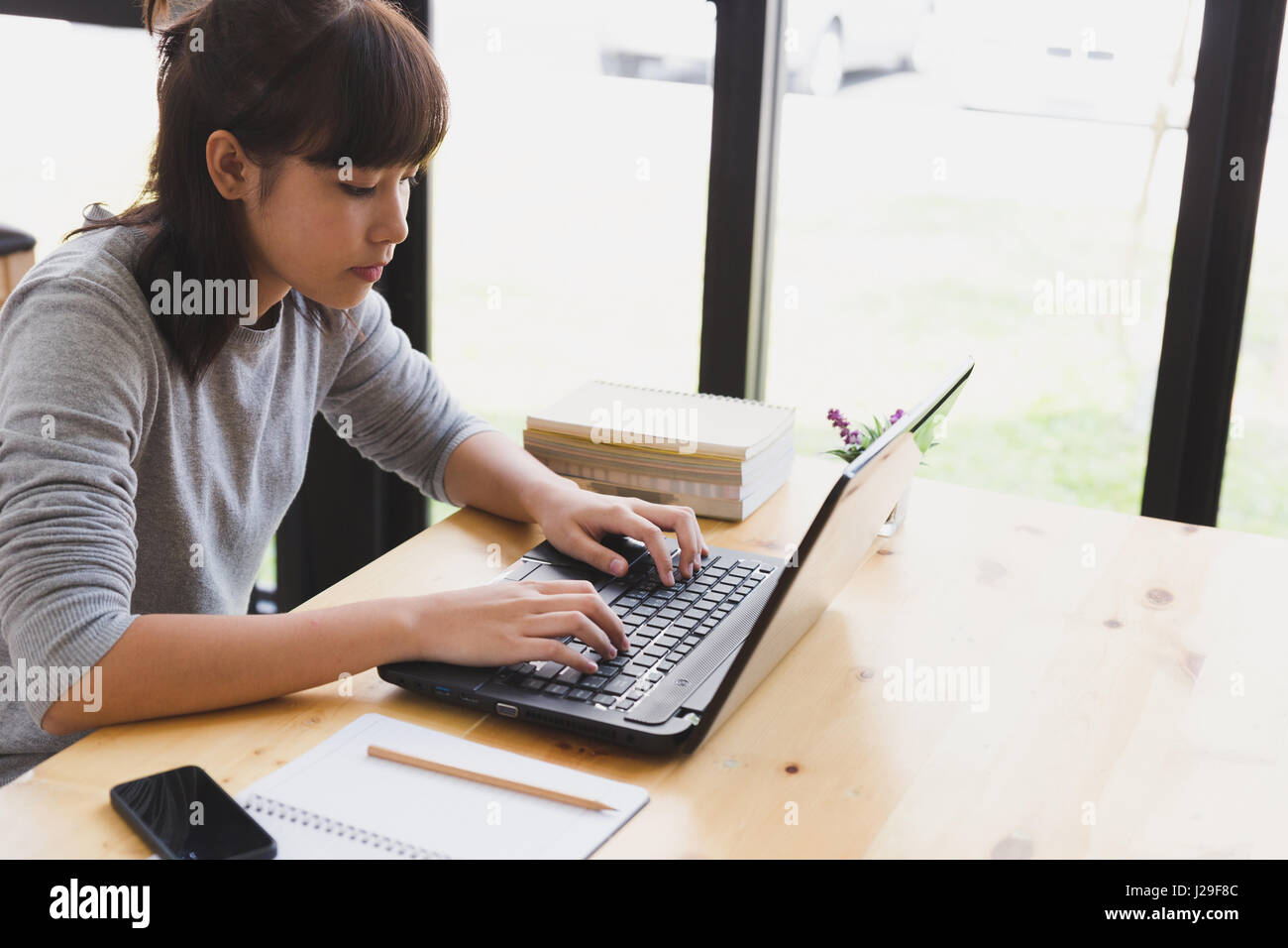 asian girl female teenager studying at school. Student typing on laptop ...