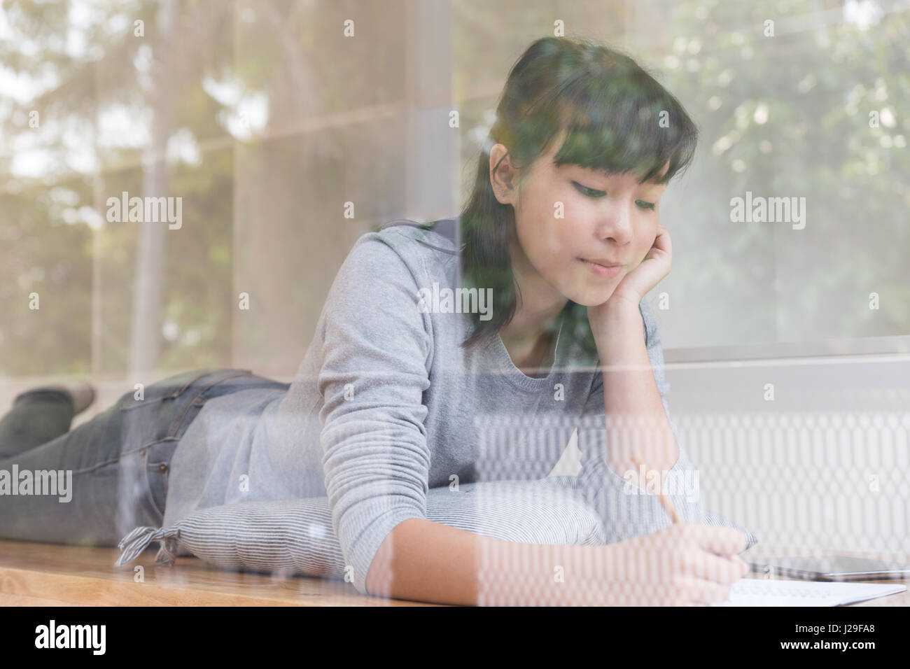 asian girl female teenager lying and studying at school. Student lying ...