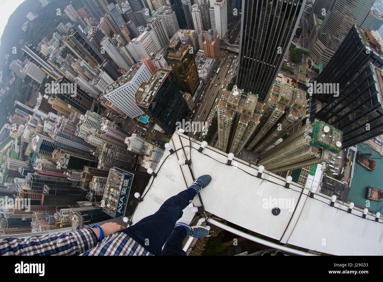 Rooftopper Denis Krasnov looks down over the traffic. MIND-BLOWING pictures of a team of thrill ...