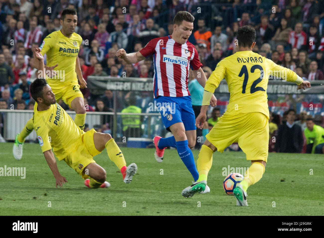 Gameiro (C) try to shoot over the pressure of Alvaro (R). (Photo by ...