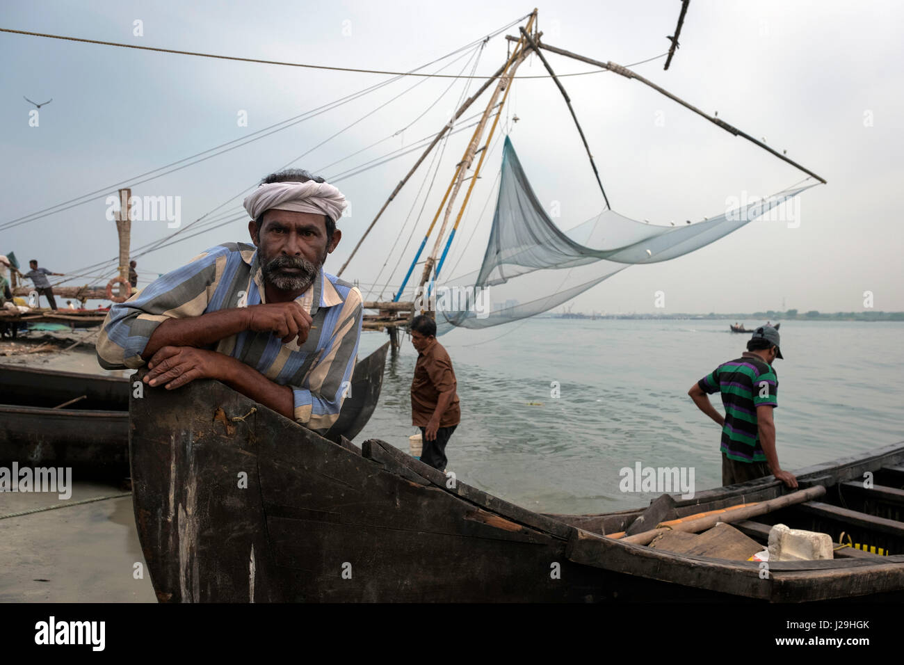 Several fishermen wait next to the boats after a day of fishing Stock ...