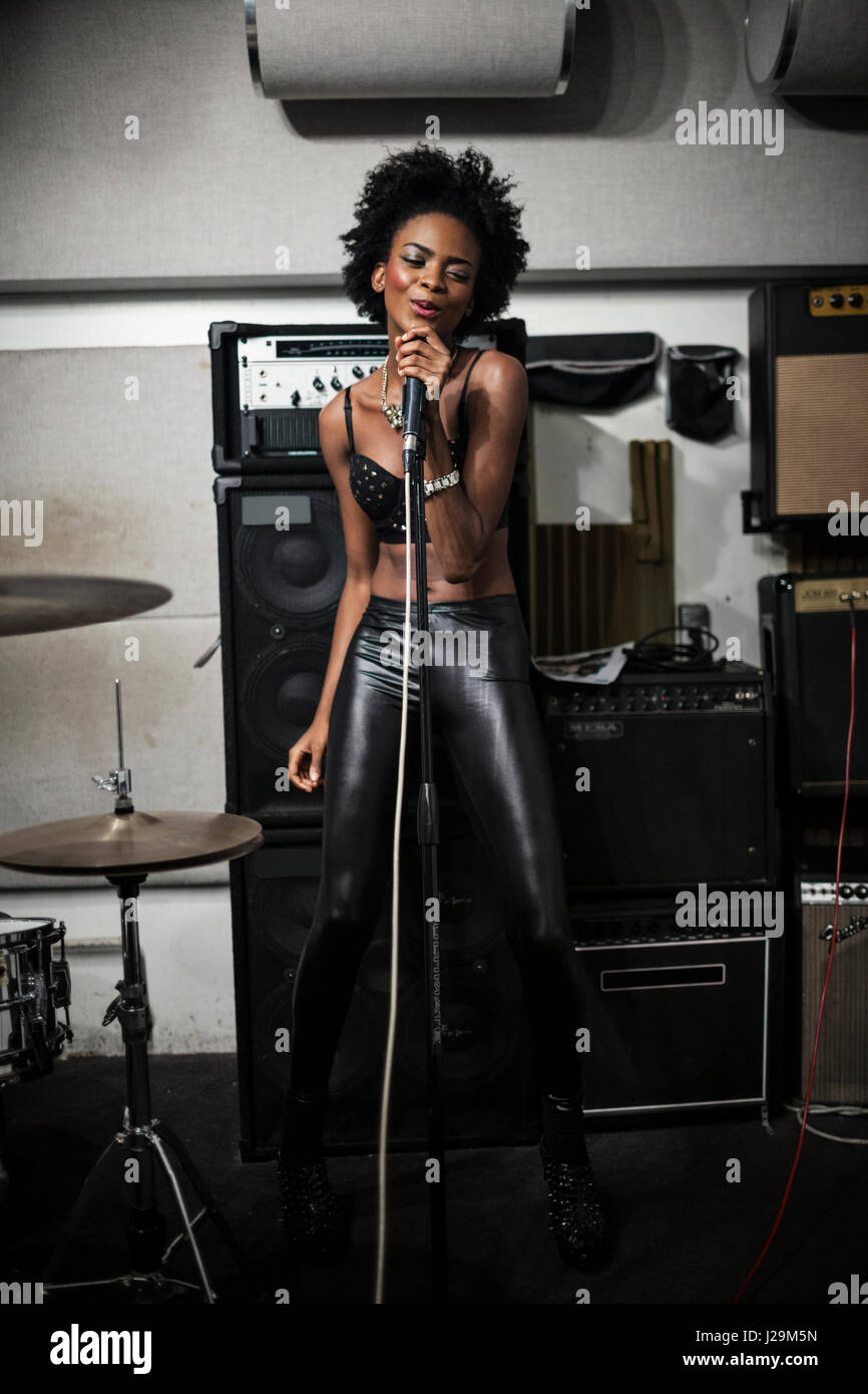 Young singer performing in a studio Stock Photo - Alamy