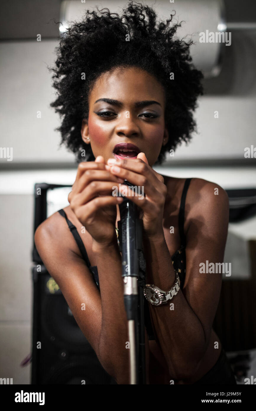 Young singer performing in a studio Stock Photo - Alamy