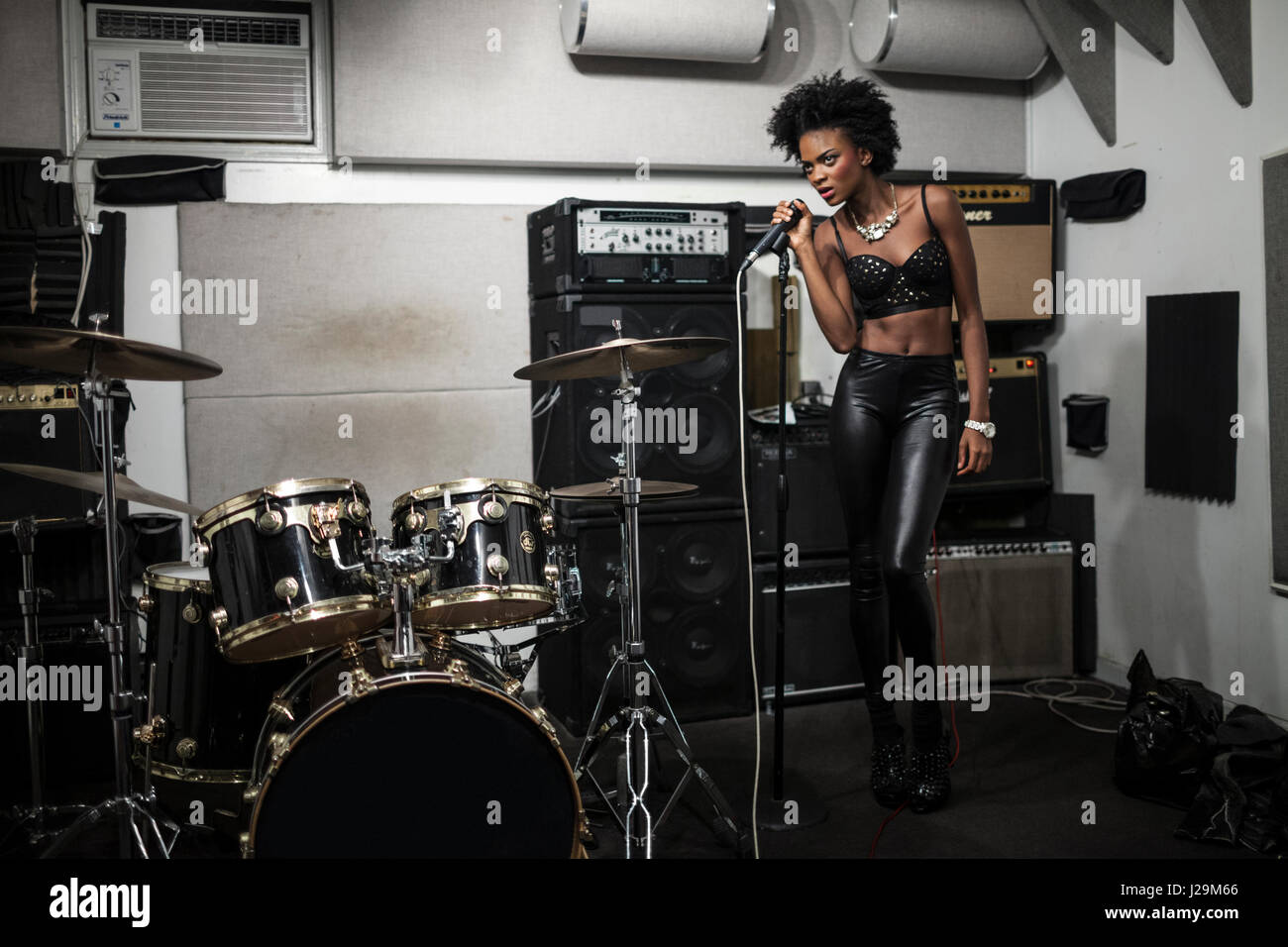 Young singer performing in a studio Stock Photo - Alamy