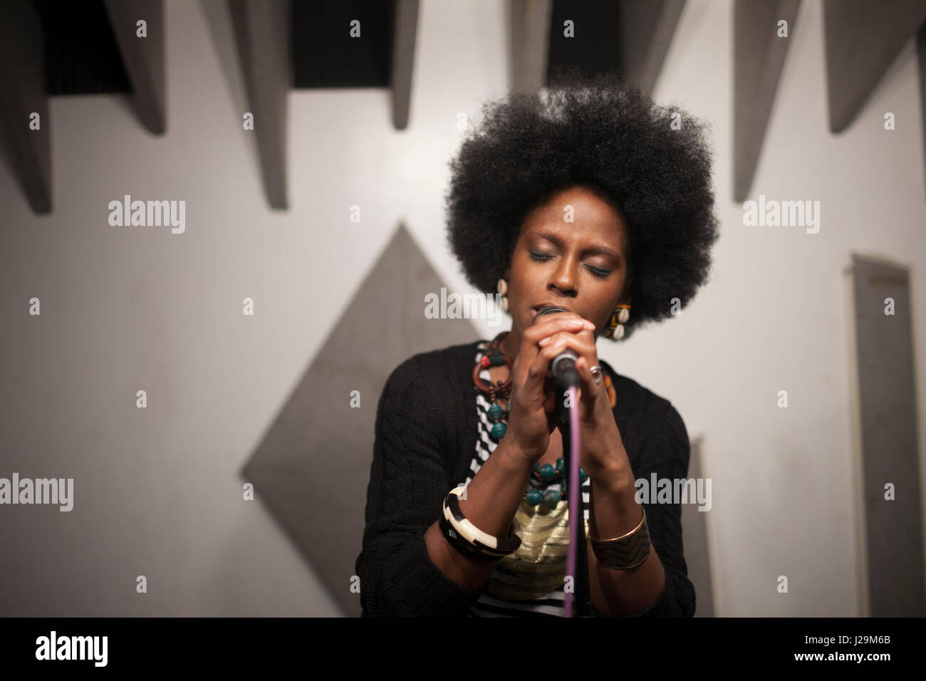 Singer performing in a recording studio Stock Photo - Alamy