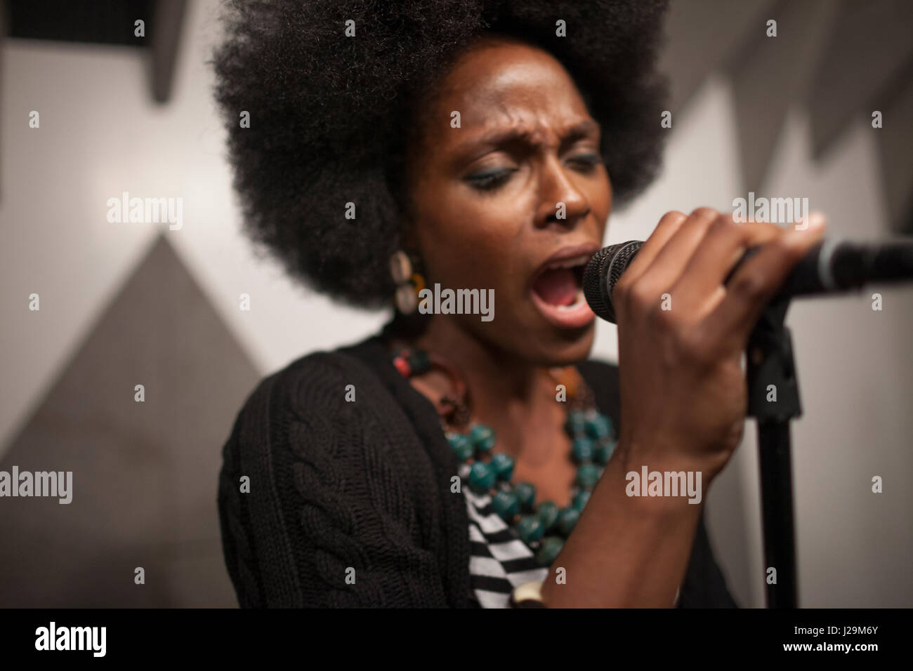Singer performing in a recording studio Stock Photo - Alamy