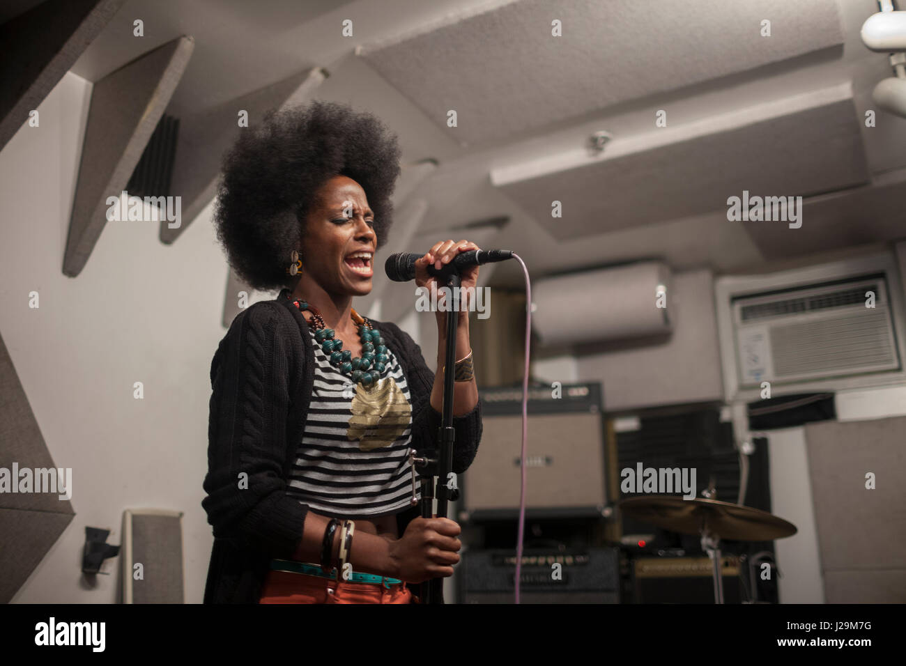 Singer performing in a recording studio Stock Photo - Alamy