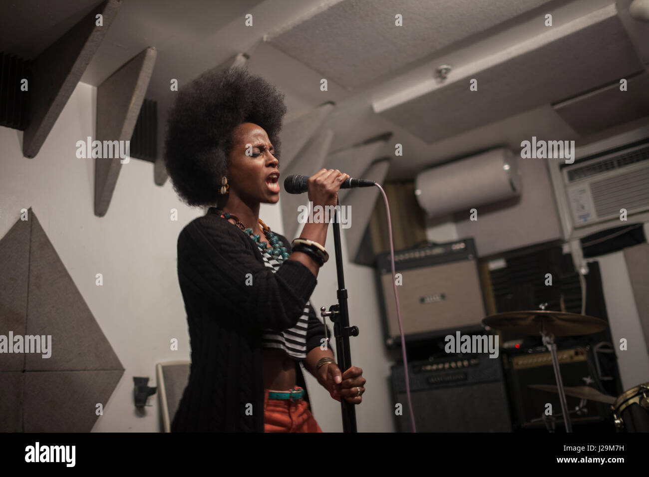 Singer performing in a recording studio Stock Photo - Alamy