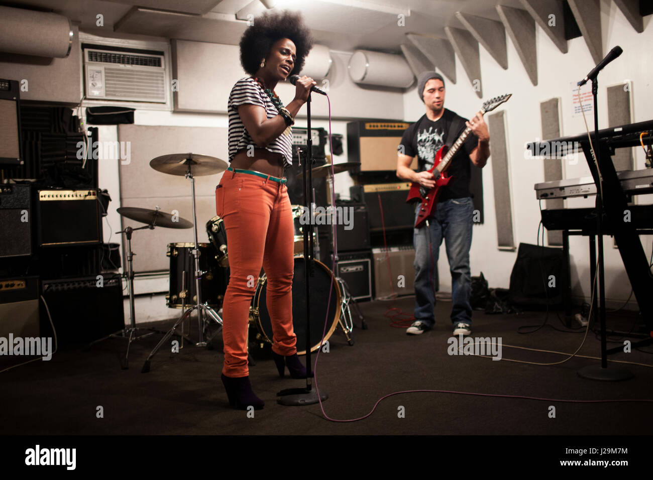 Young singer performing in a studio Stock Photo - Alamy
