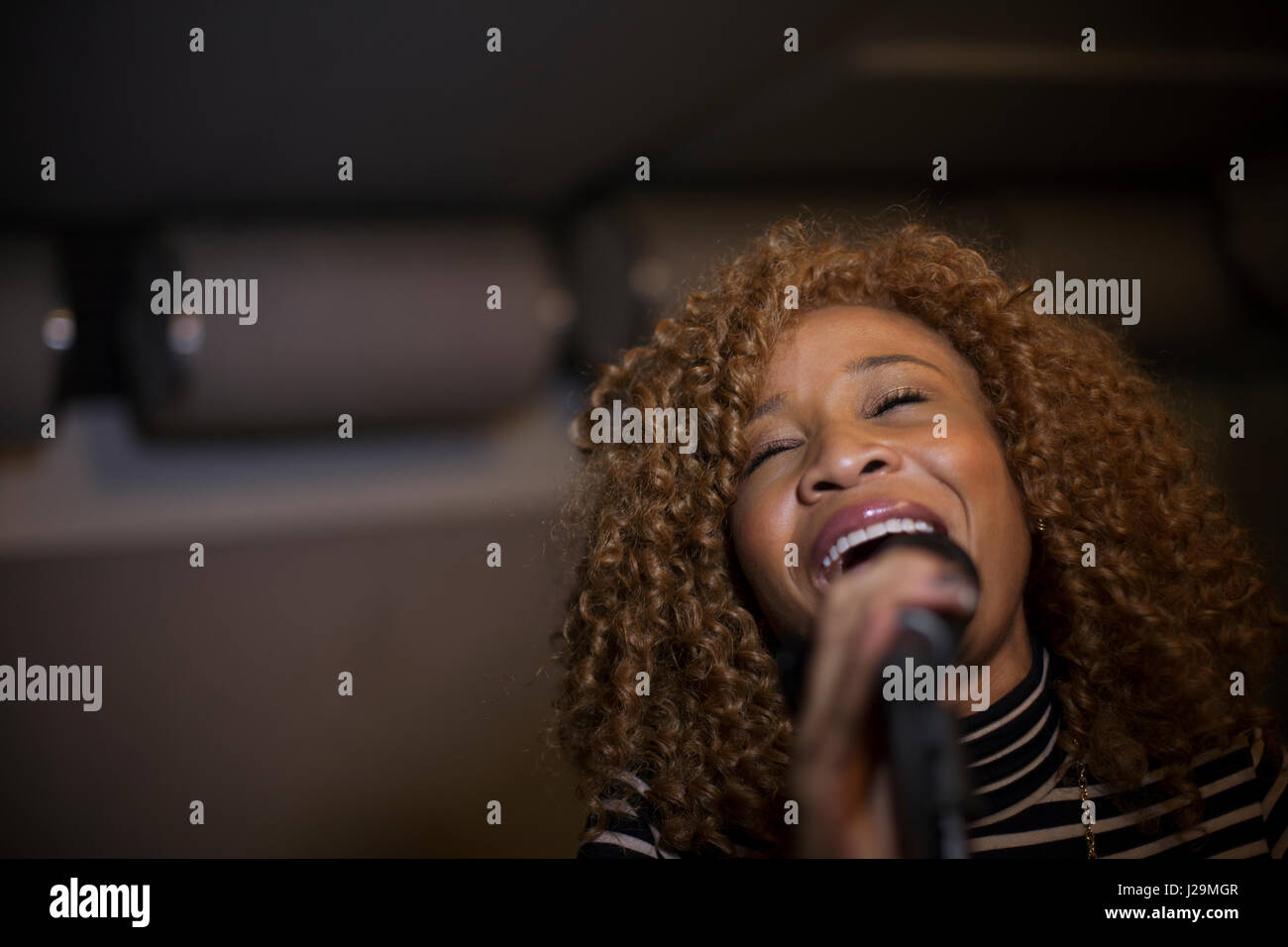 Singer performing in a recording studio Stock Photo - Alamy