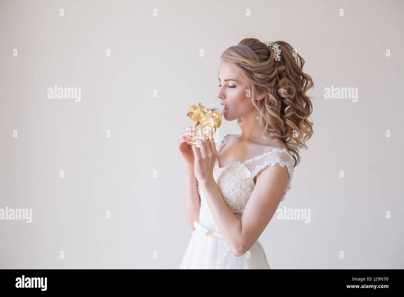 the bride at a wedding in room eating white chocolate Stock Photo - Alamy