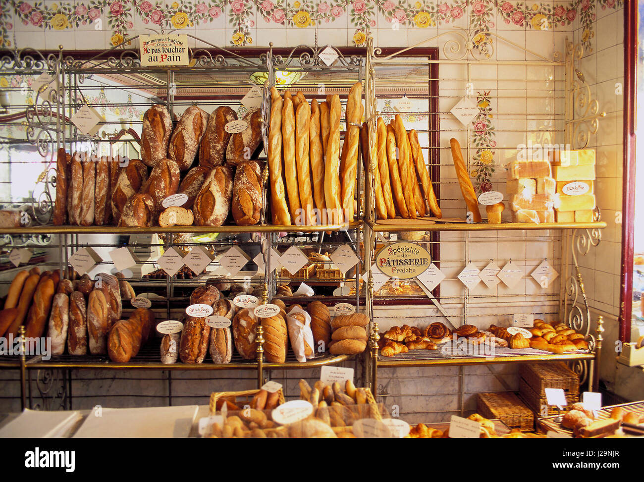 France, Paris, old bakery with breads and decorated with ceramics ...