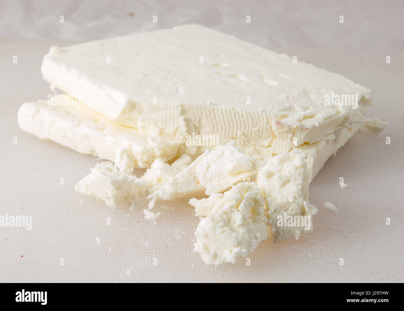 Black feta cheese in studio on white background Stock Photo - Alamy