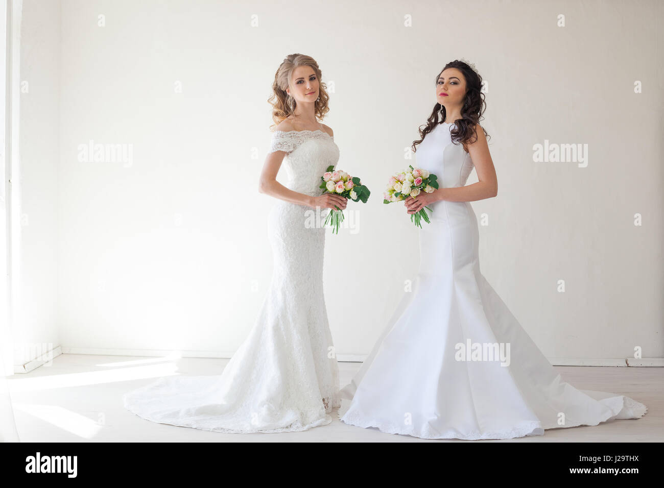 two wedding bride with bouquet wedding Stock Photo - Alamy