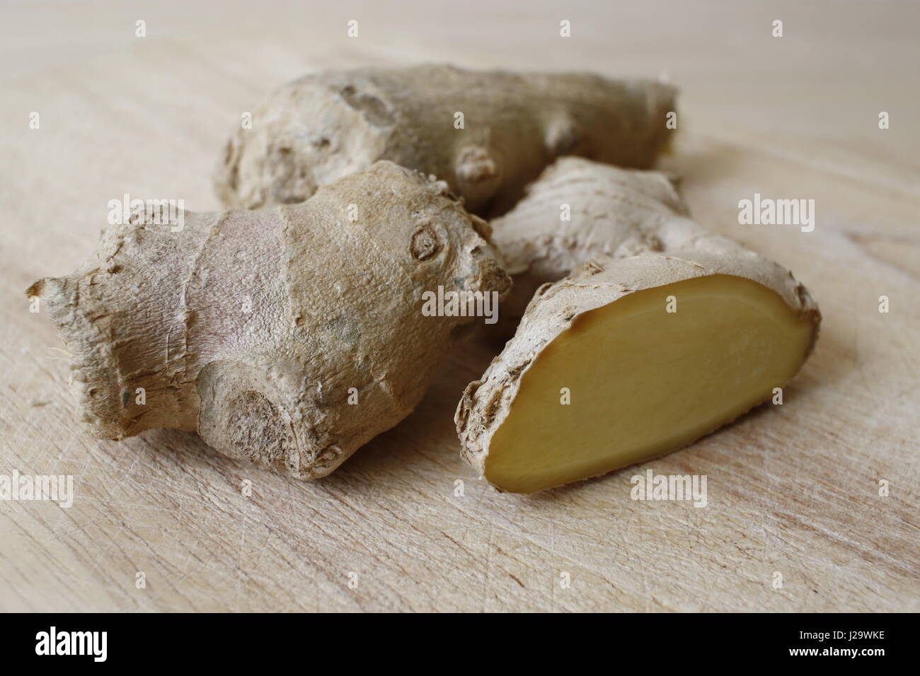 Pieces of ginger root on a wodden plate Stock Photo - Alamy