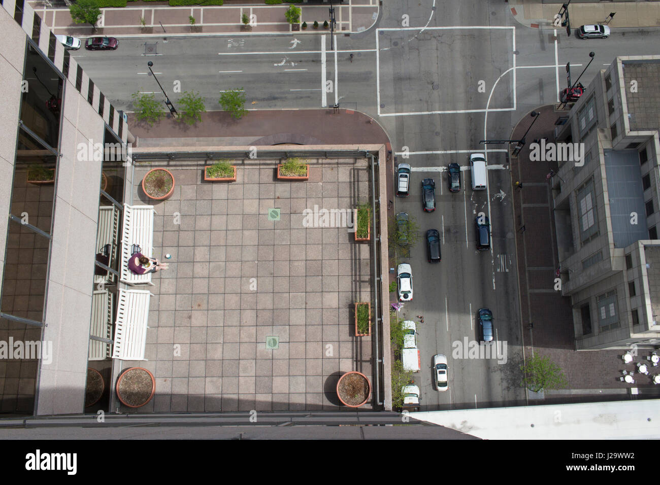 Photo taken looking down the side of a building at the balcony and city ...