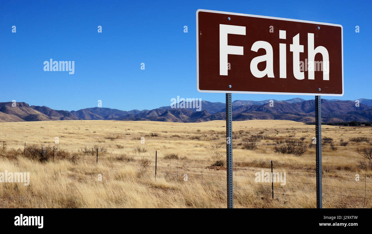 Faith road sign with blue sky and wilderness Stock Photo - Alamy