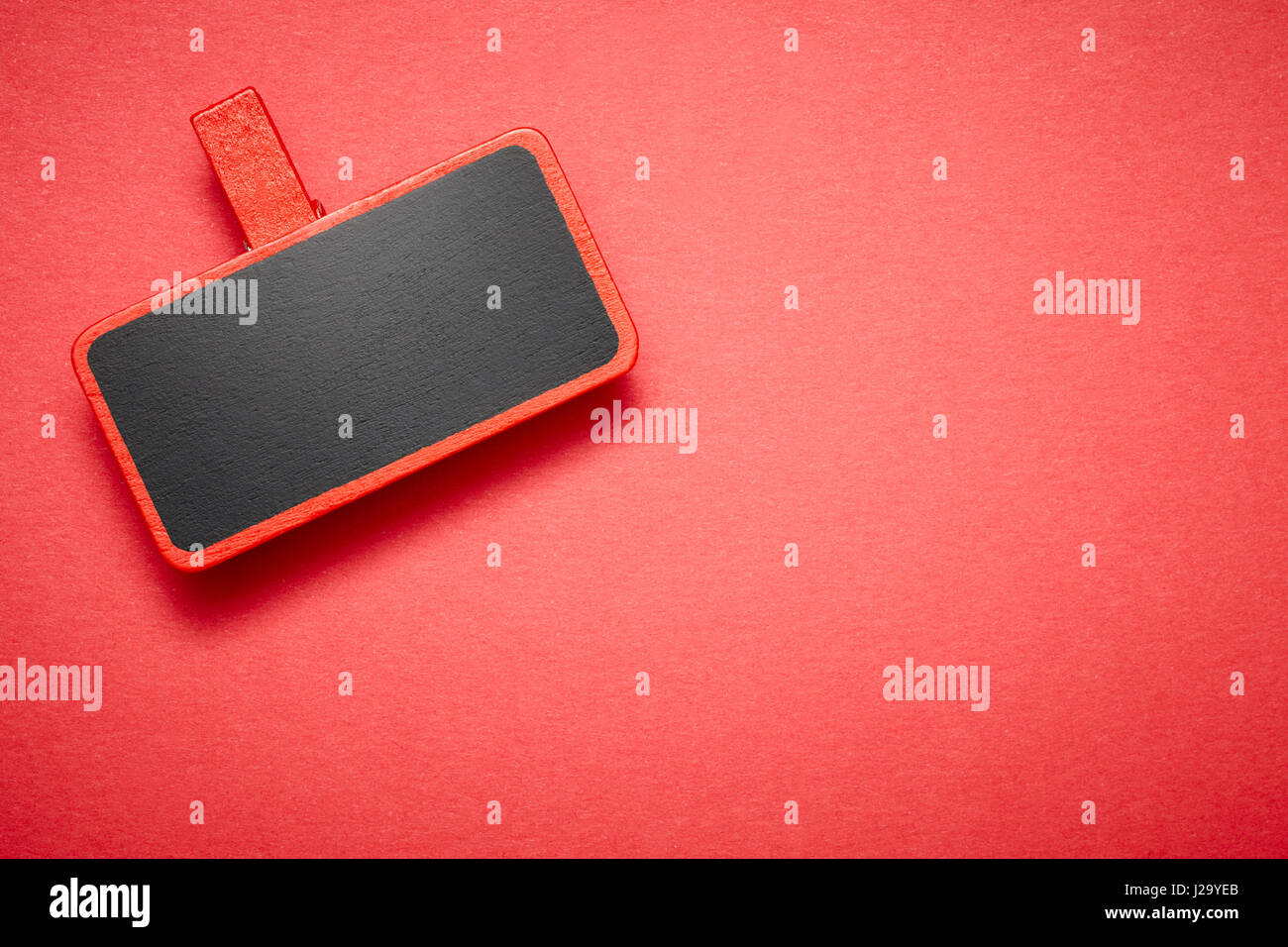 red label on the red background Stock Photo - Alamy