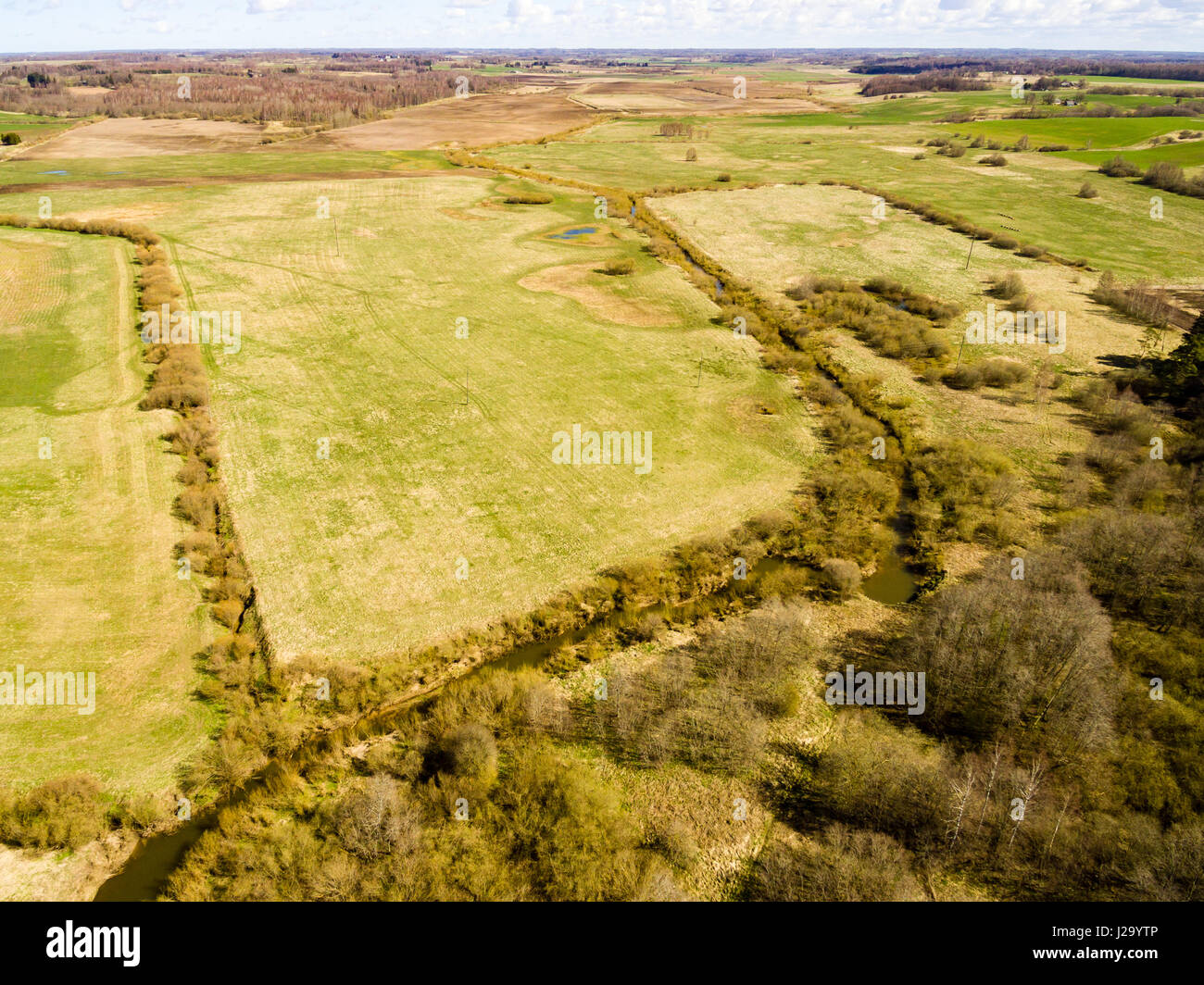 drone image. aerial view of rural area with river in forest in sunny ...