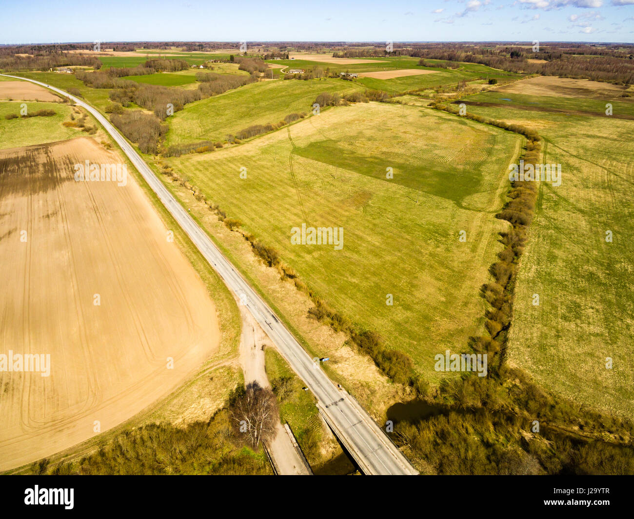 drone image. aerial view of rural area with river in forest in sunny ...