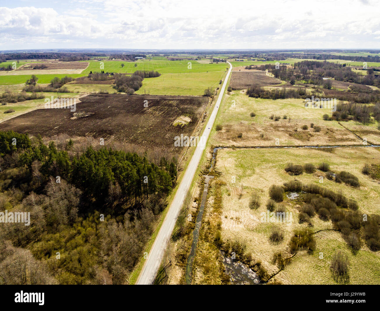 drone image. aerial view of rural area with river in forest in sunny ...