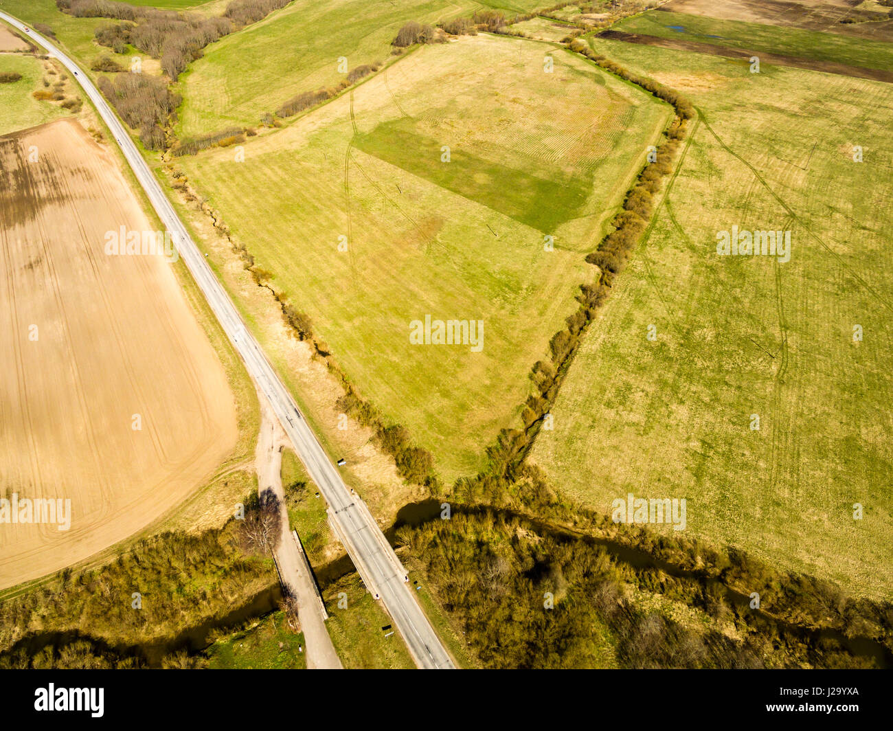 drone image. aerial view of rural area with river in forest in sunny ...
