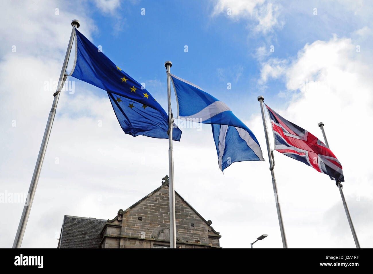 A Scottish saltire, the union flag, and the flag of the European Union ...