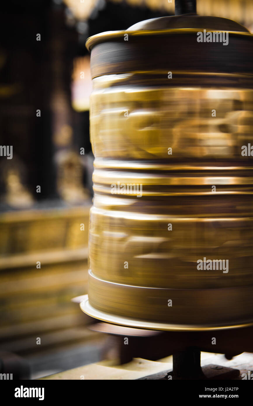A long exposure shot of a spinning golden prayer wheel in the Golden ...