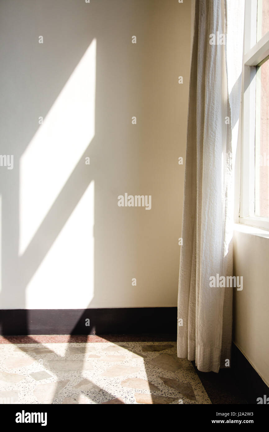 Early morning light streaming through a window and onto a floor made of ...