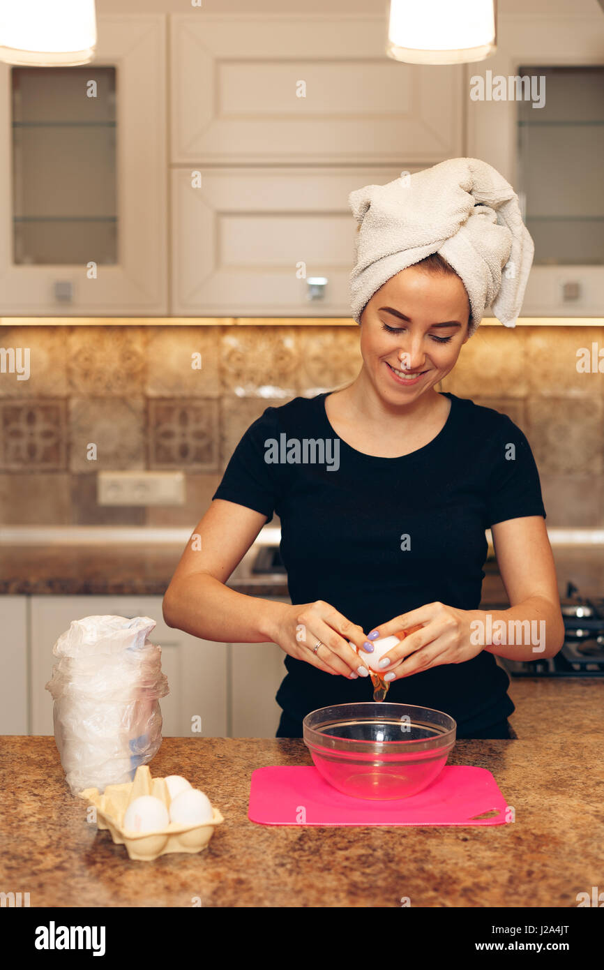 Young woman with a towel on her head preparing breakfast Stock Photo ...
