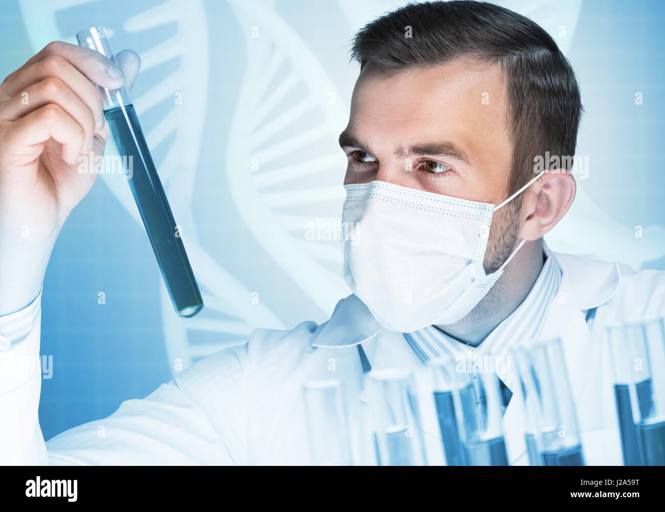 Portrait of concentrated male scientist working with reagents in ...