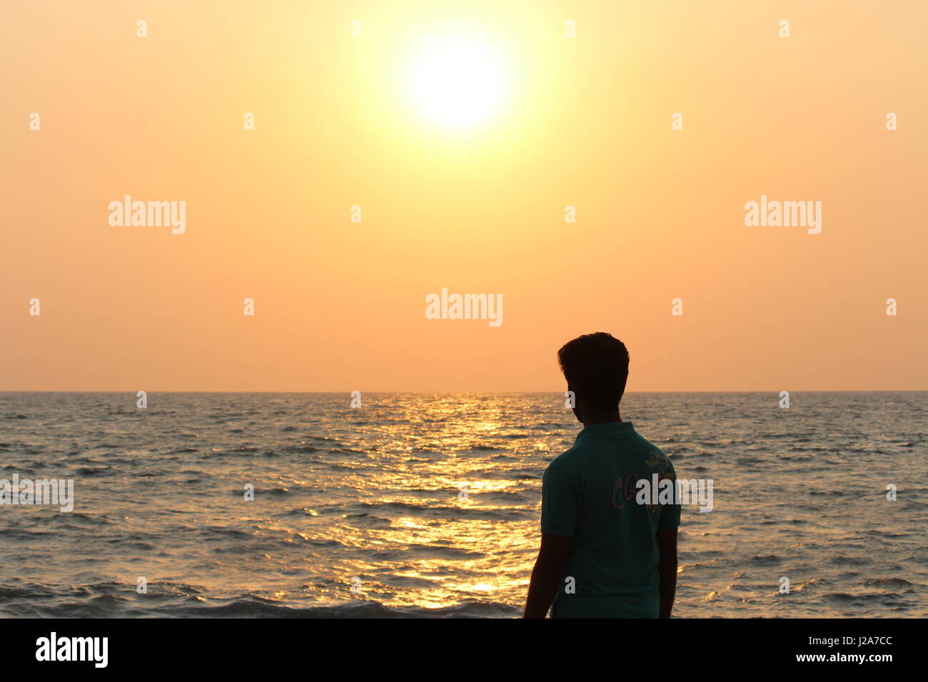 Boy watching sea sunset hi-res stock photography and images - Alamy