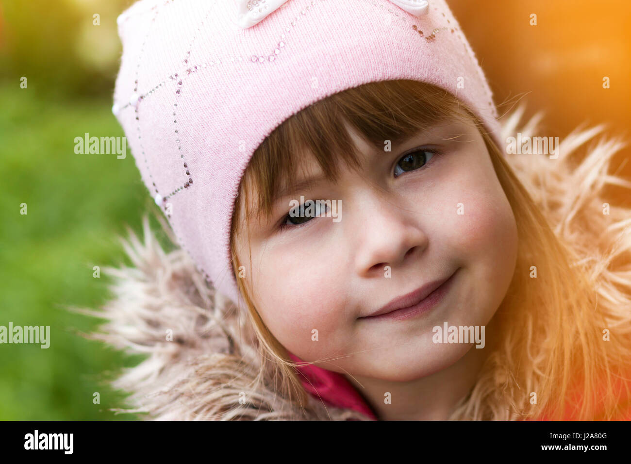 Close-up portrait of happy smiling pretty little girl. Soft light ...