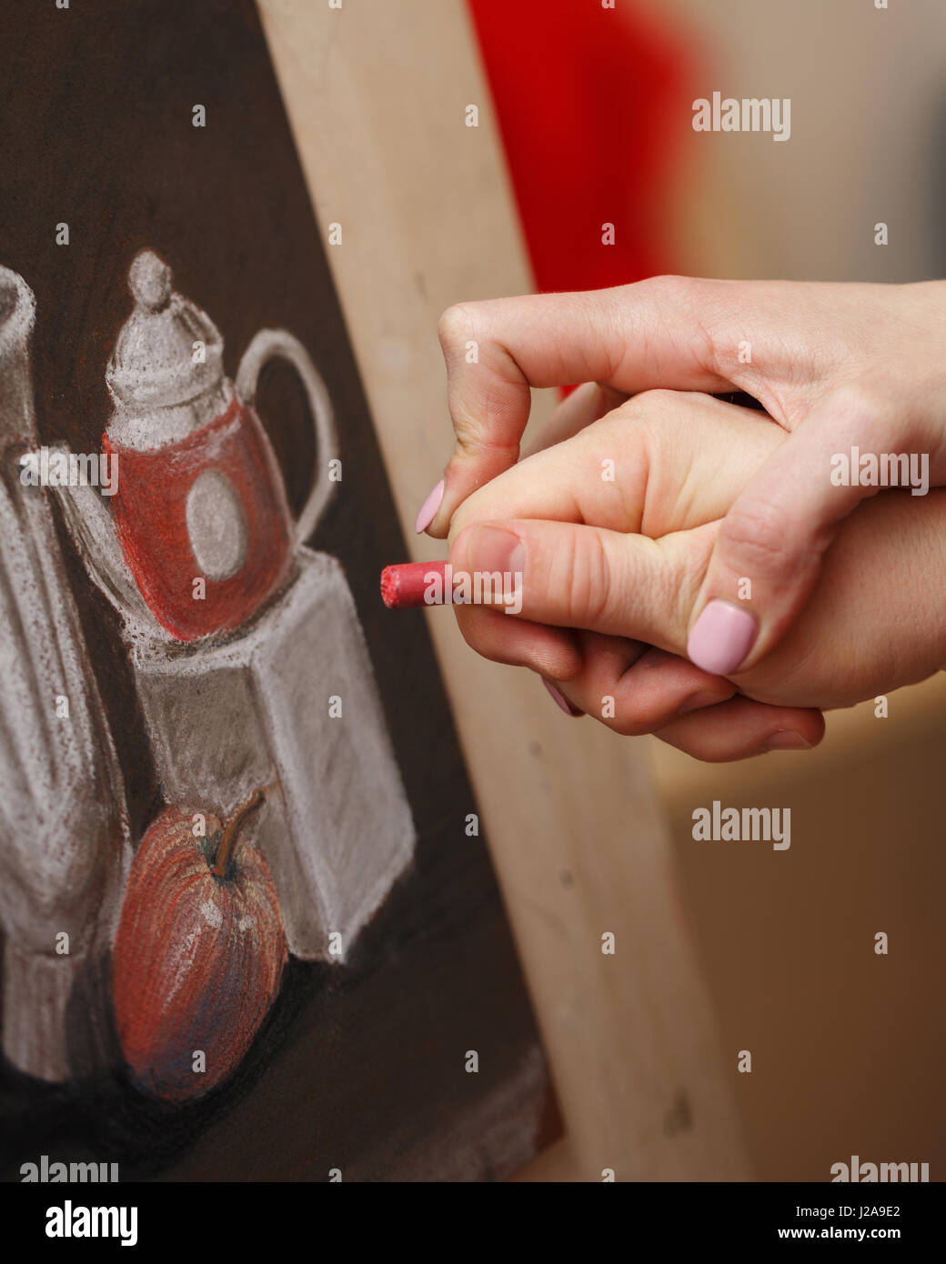 The man draws a still life with pastel crayons in an art school. The ...