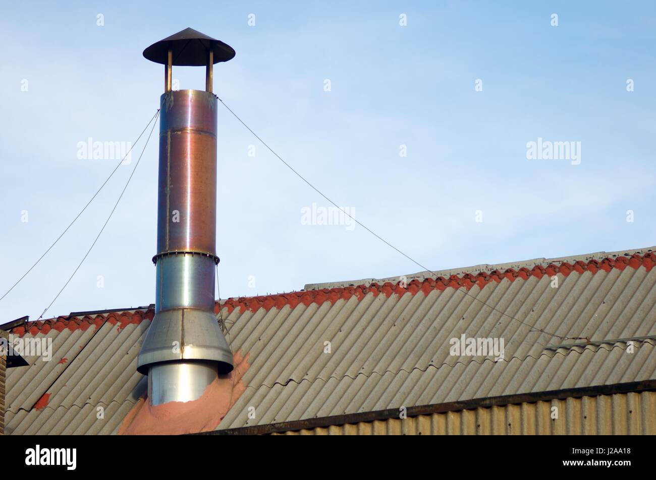 Closeup of a small smokestack on a tin roof Stock Photo - Alamy