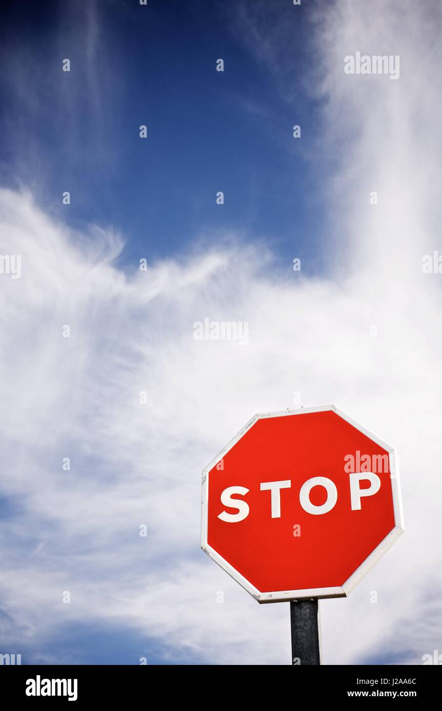 forefront of a stop sign with a cloudy sky Stock Photo - Alamy