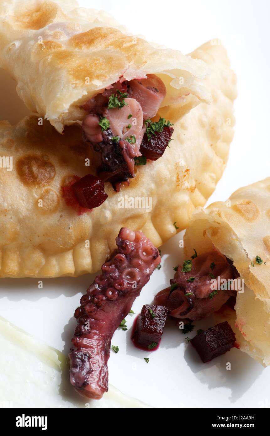 forefront of some octopus dumplings, potato and beet Stock Photo - Alamy