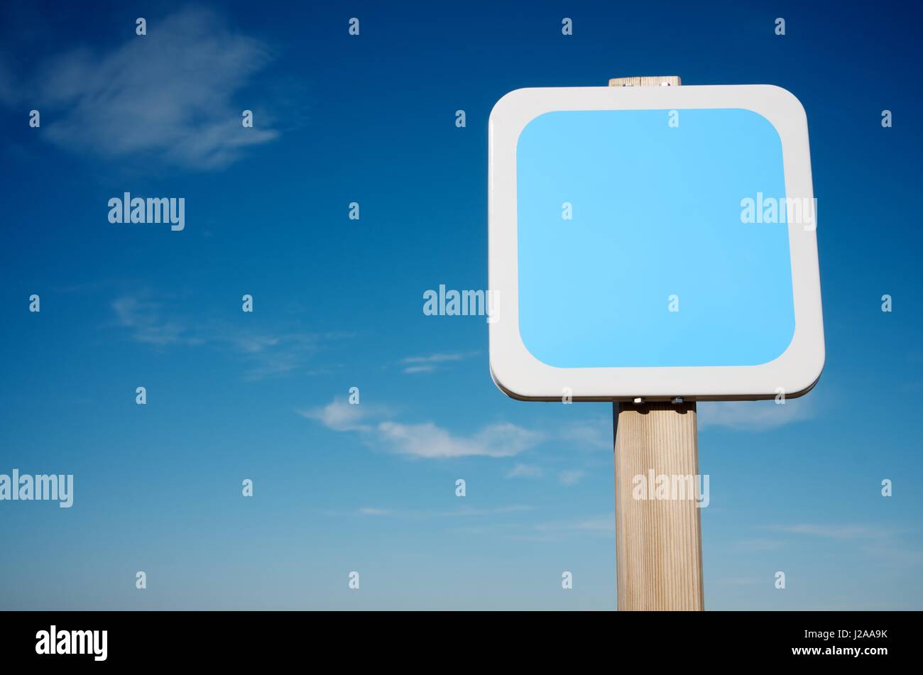 foreground of a square white sign with blue sky Stock Photo - Alamy
