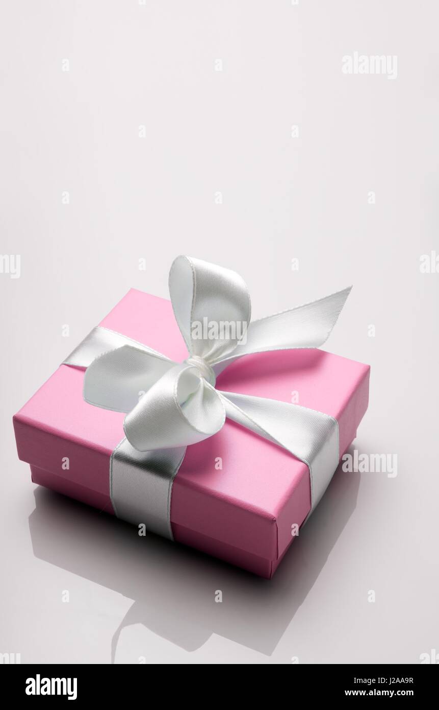 small pink box tied with a white ribbon Stock Photo - Alamy