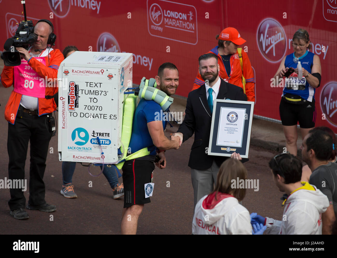 Man carries a washing machine on his back at the Virgin Money London ...