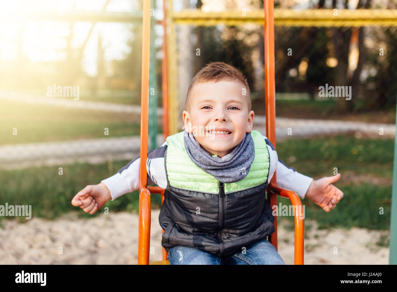 Little boy play on playground with white blur park background Stock ...
