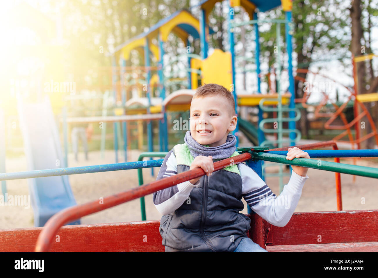 Little boy play on playground with white blur park background Stock ...