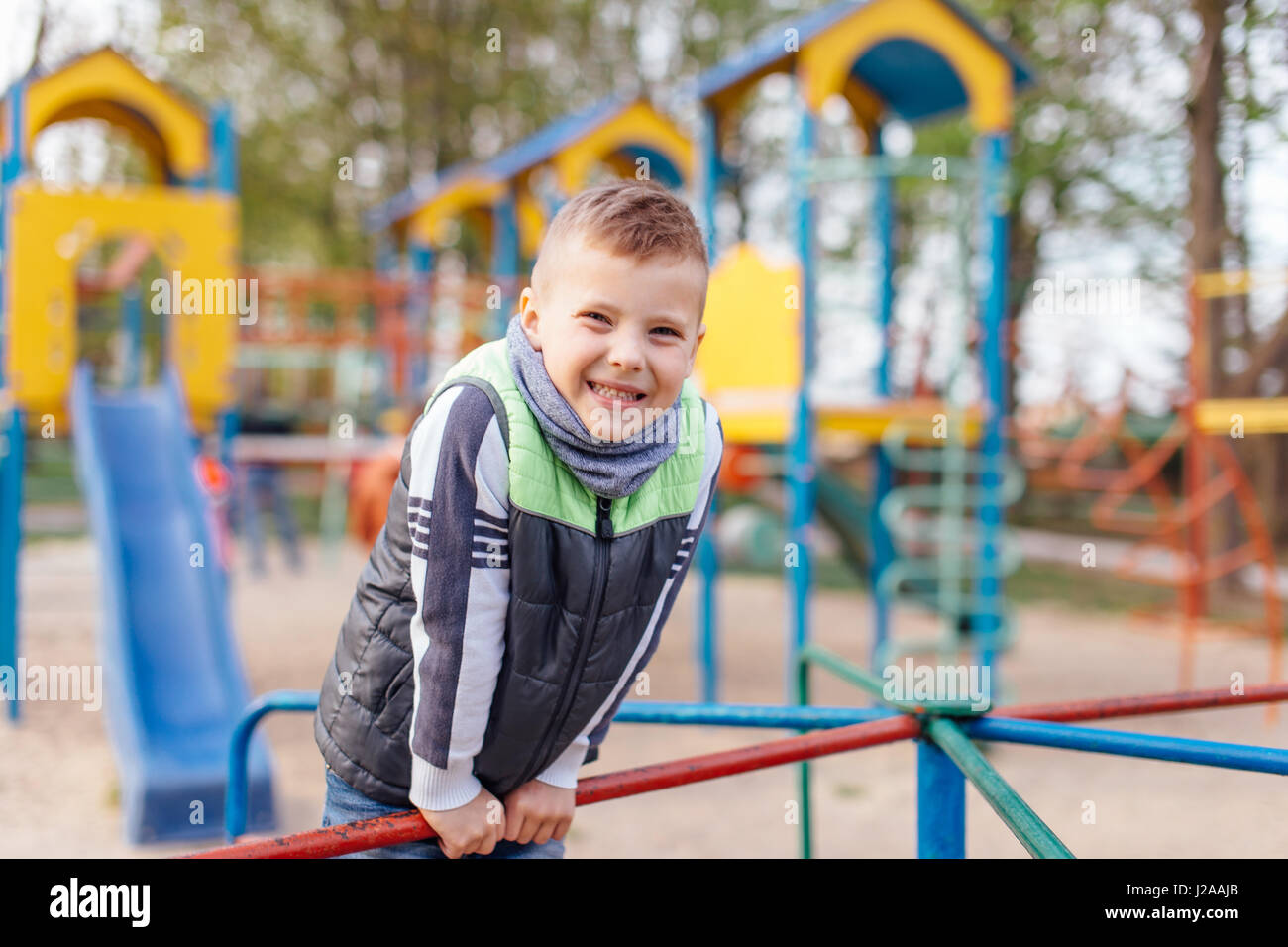 Little boy play on playground with white blur park background Stock ...