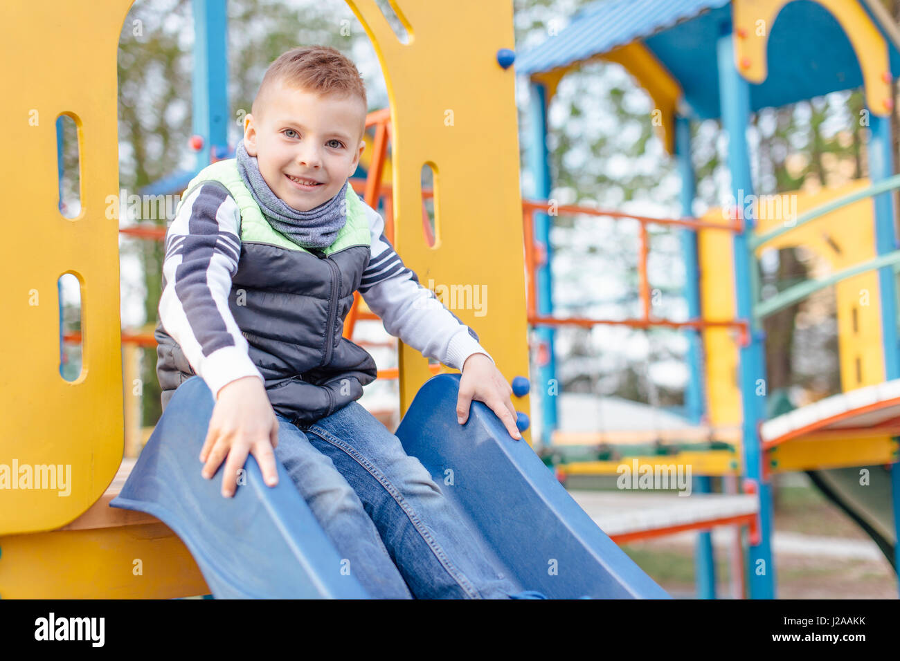 Little boy play on playground with white blur park background Stock ...