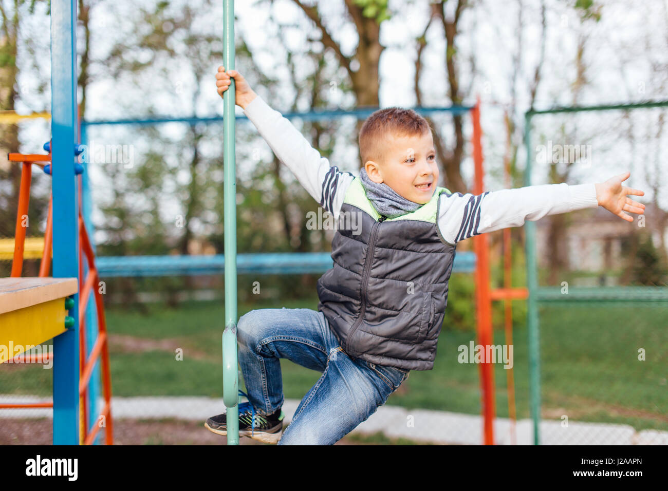 Little boy play on playground with white blur park background Stock ...