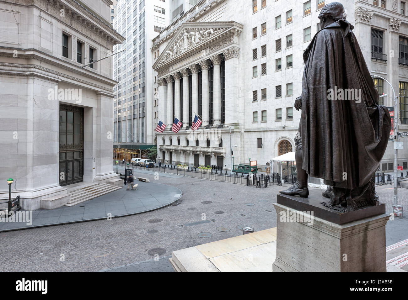 A view of Wall Street from the steps of the Federal Hall on a sunny day ...