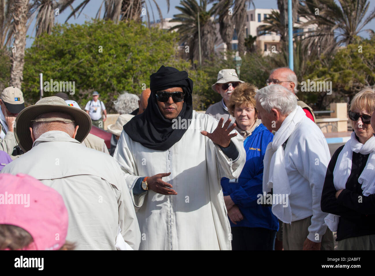 Africa, Western Sahara, Dakhla. Guide talking to tourists Stock Photo ...